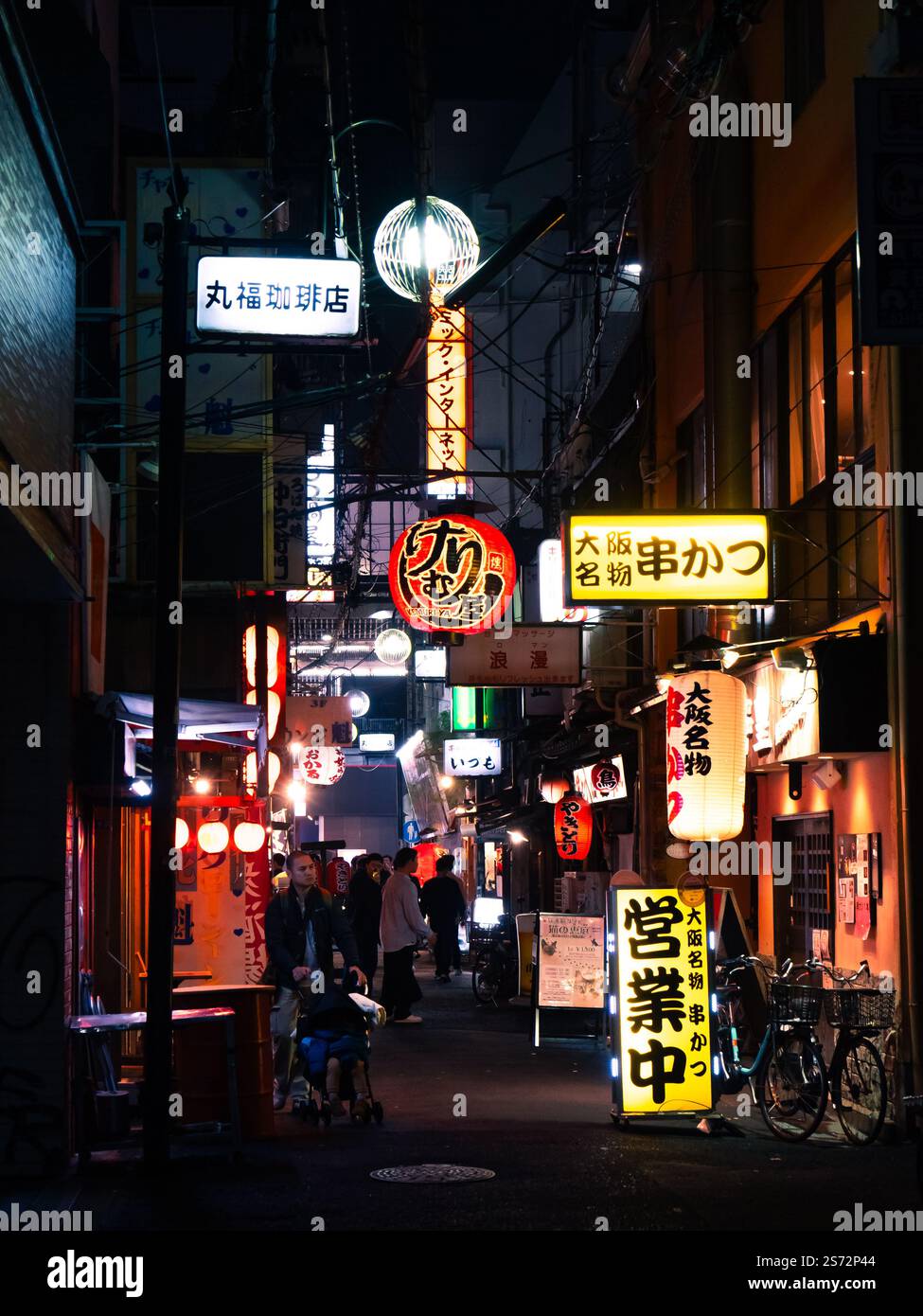 A vibrant night scene in Osaka's Dotonbori district, illuminated by ...