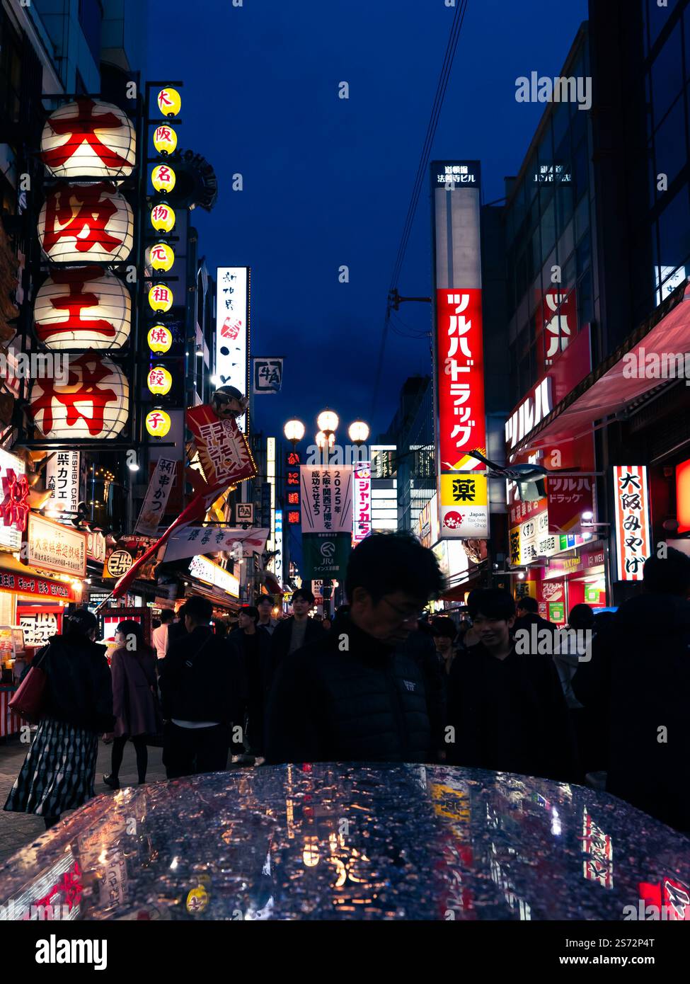 A vibrant night scene in Osaka's Dotonbori district, illuminated by ...