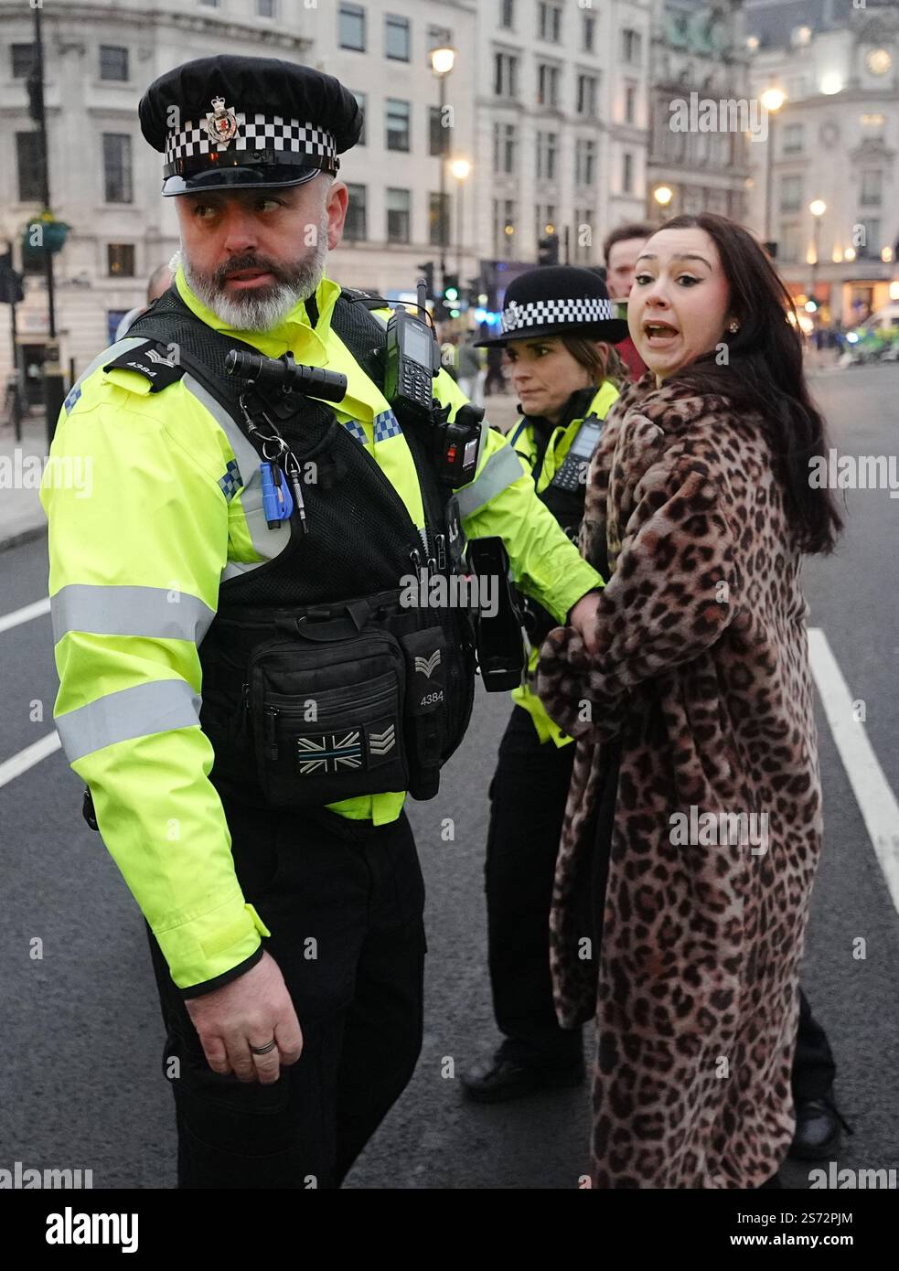 A police officer holding a persons arm during a national march for ...