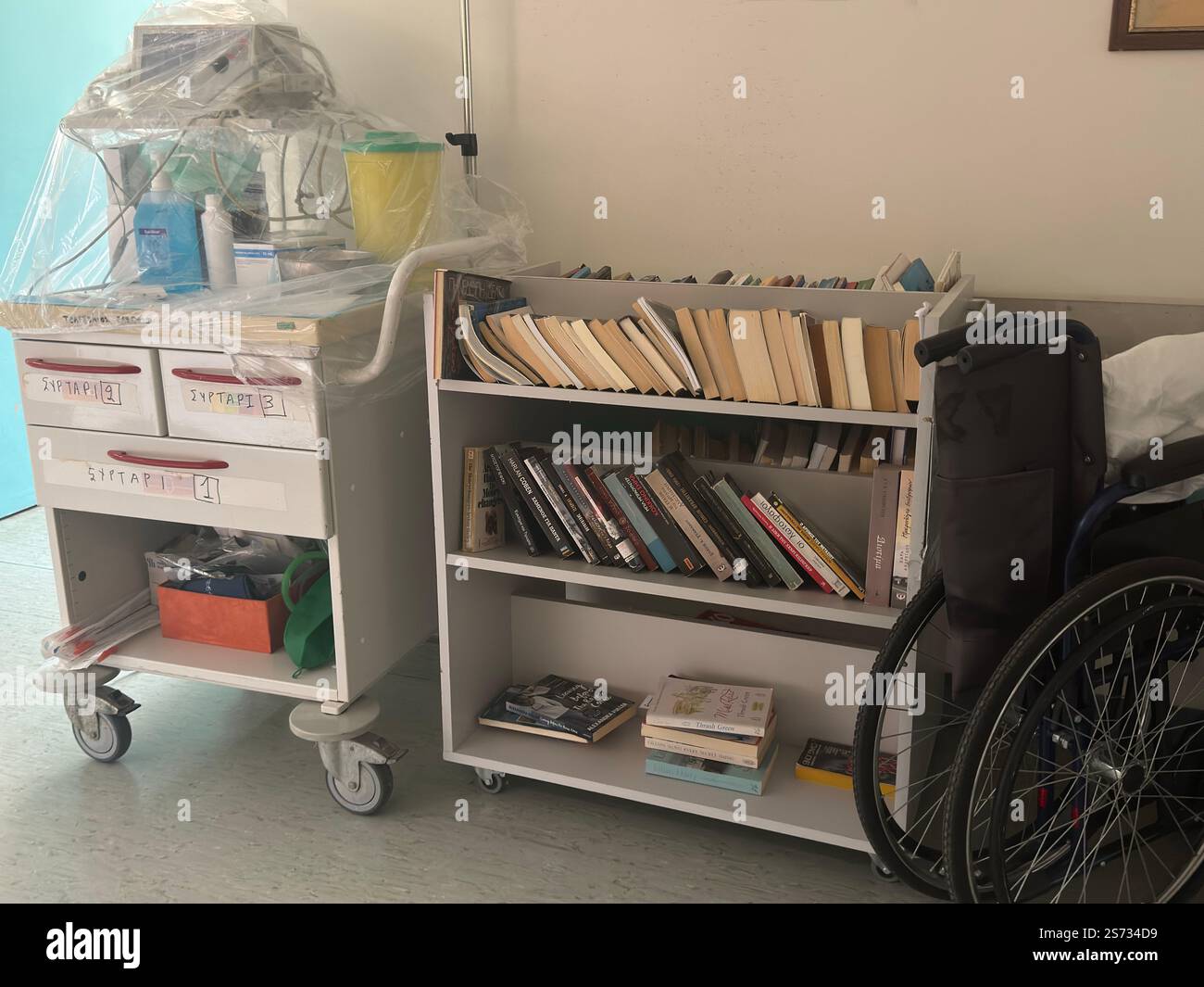Μobile lending library in hospital - A trolley with books between a ...
