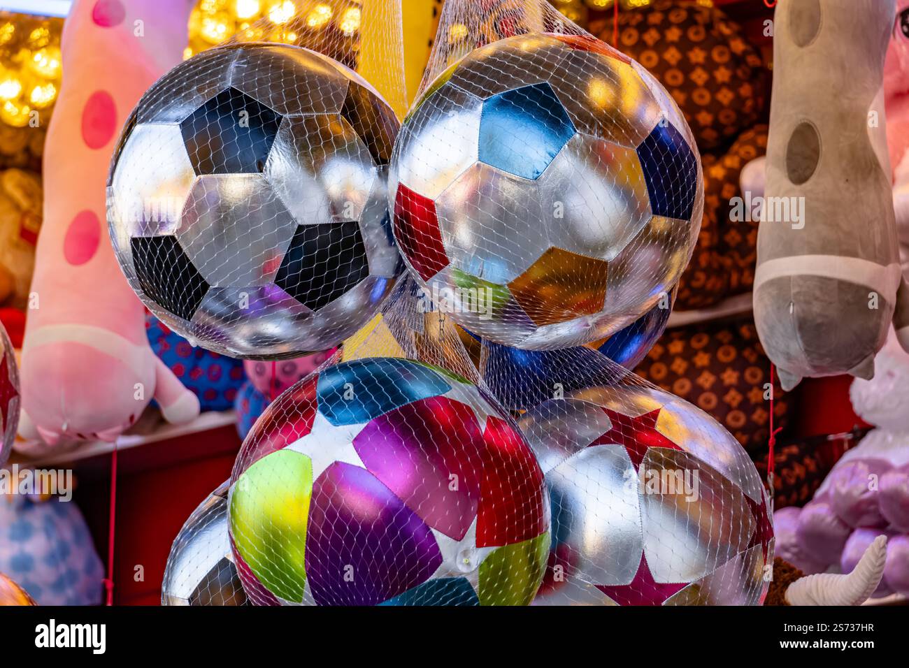 A bunch of colorful balls with a soccer ball in the middle. The balls ...