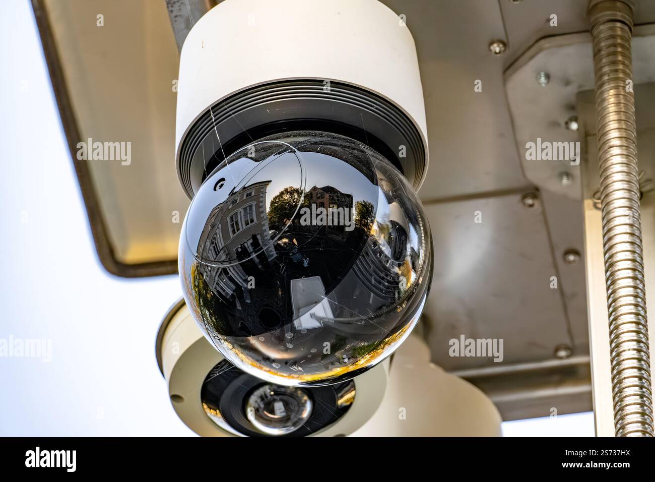 A camera is mounted on a pole and is looking down. The camera is black ...