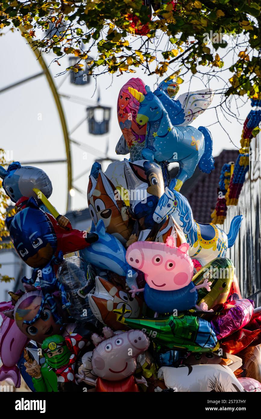 A bunch of balloons with different characters on them, including Peppa ...