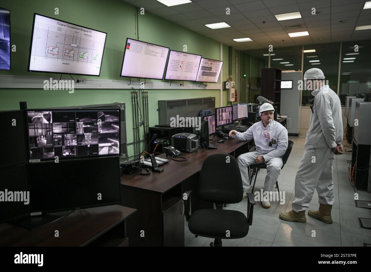 Technicians work in a monitoring station inside the new safe ...