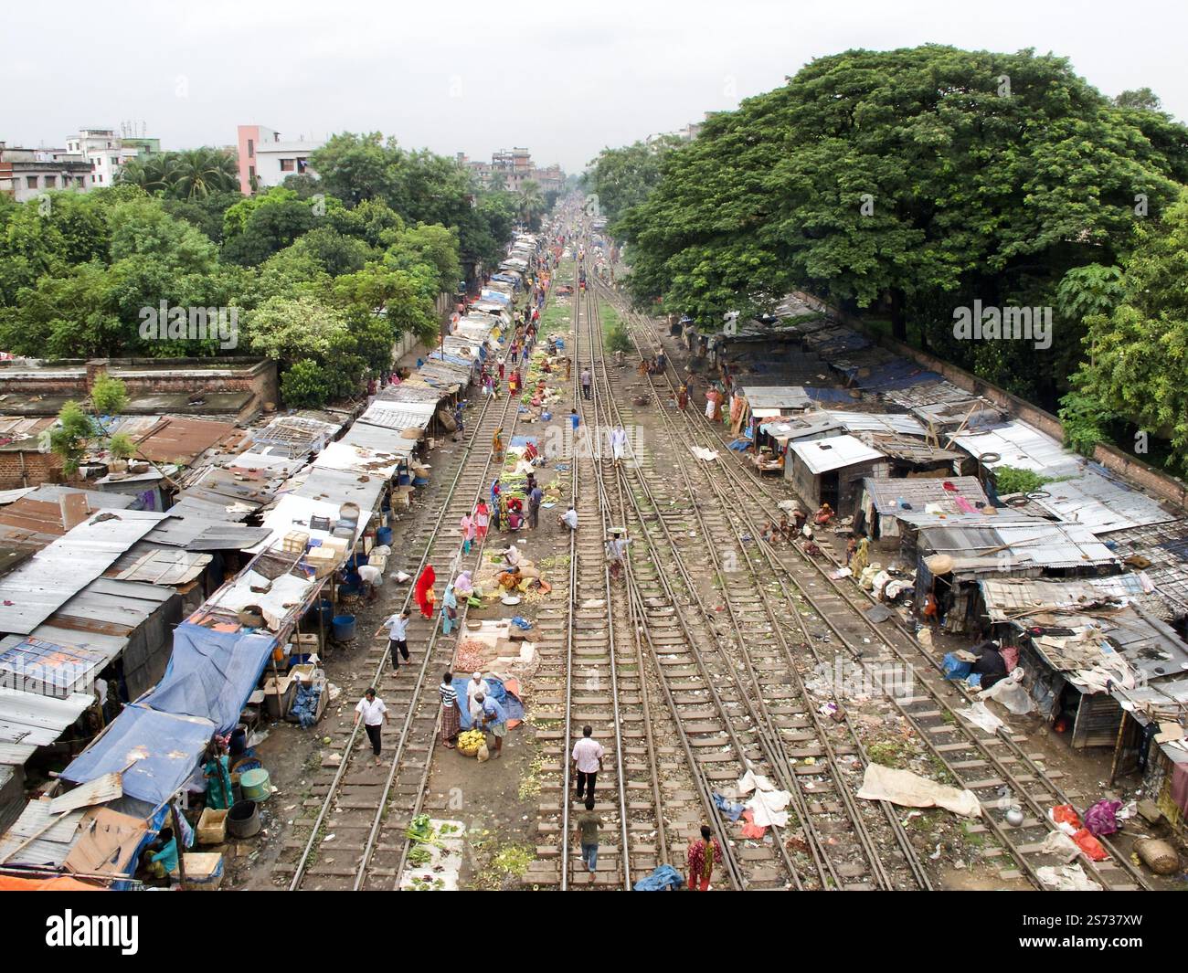 Informal housing and street trade along the train tracks in Kilgaon, Dhaka, Bangladesh ...