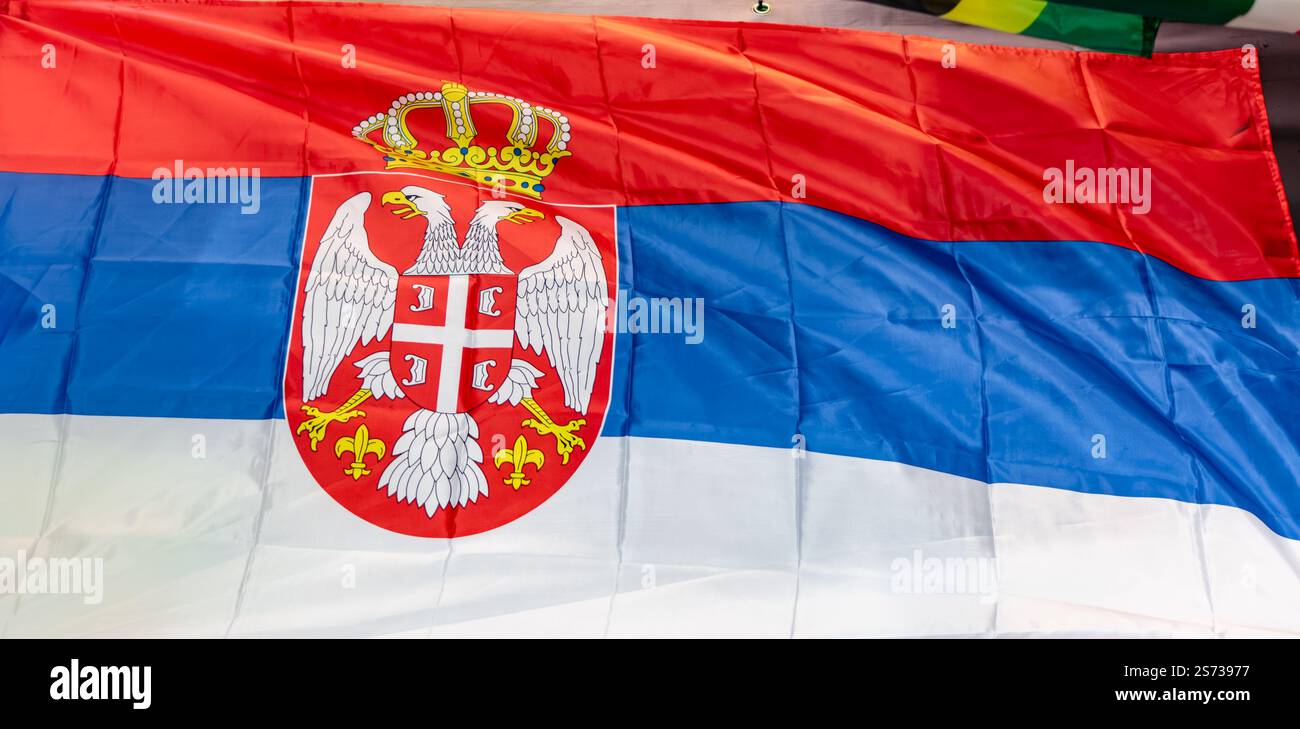 A red, white and blue flag with a crown on top. The flag is from the ...