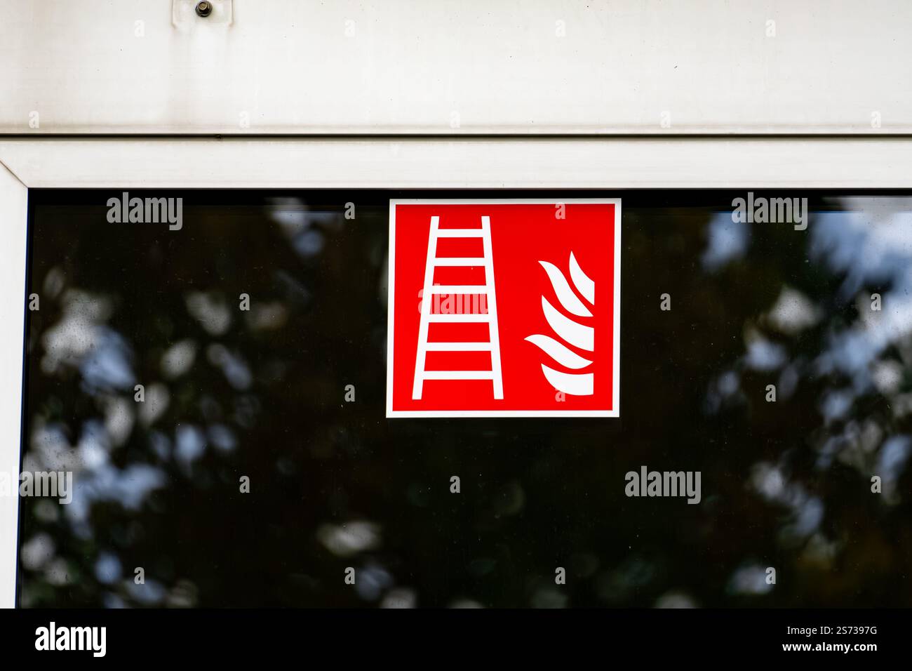A red sign with a ladder and a fire symbol on it. The fire symbol is ...