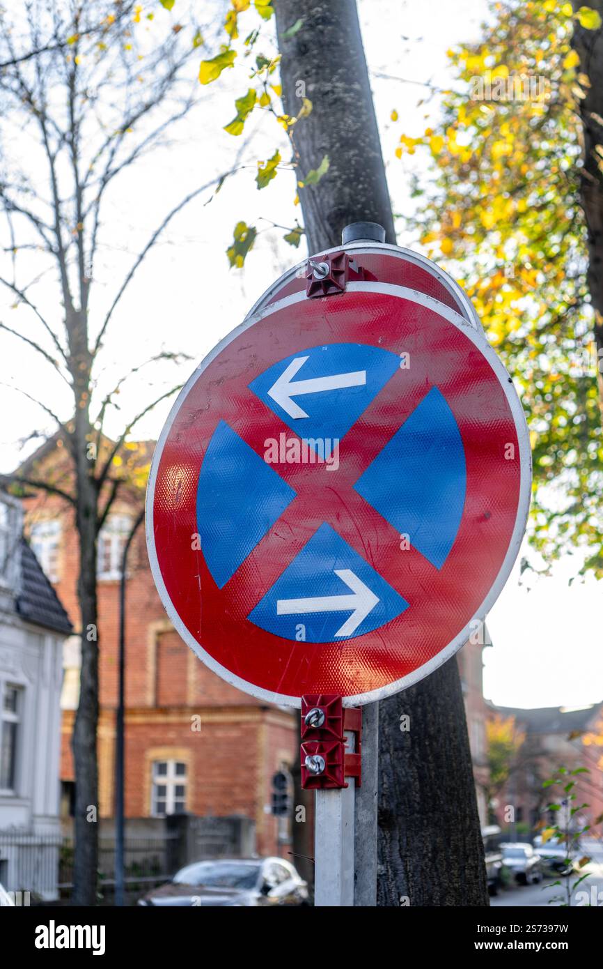 A red and blue sign with an arrow pointing to the left and another ...