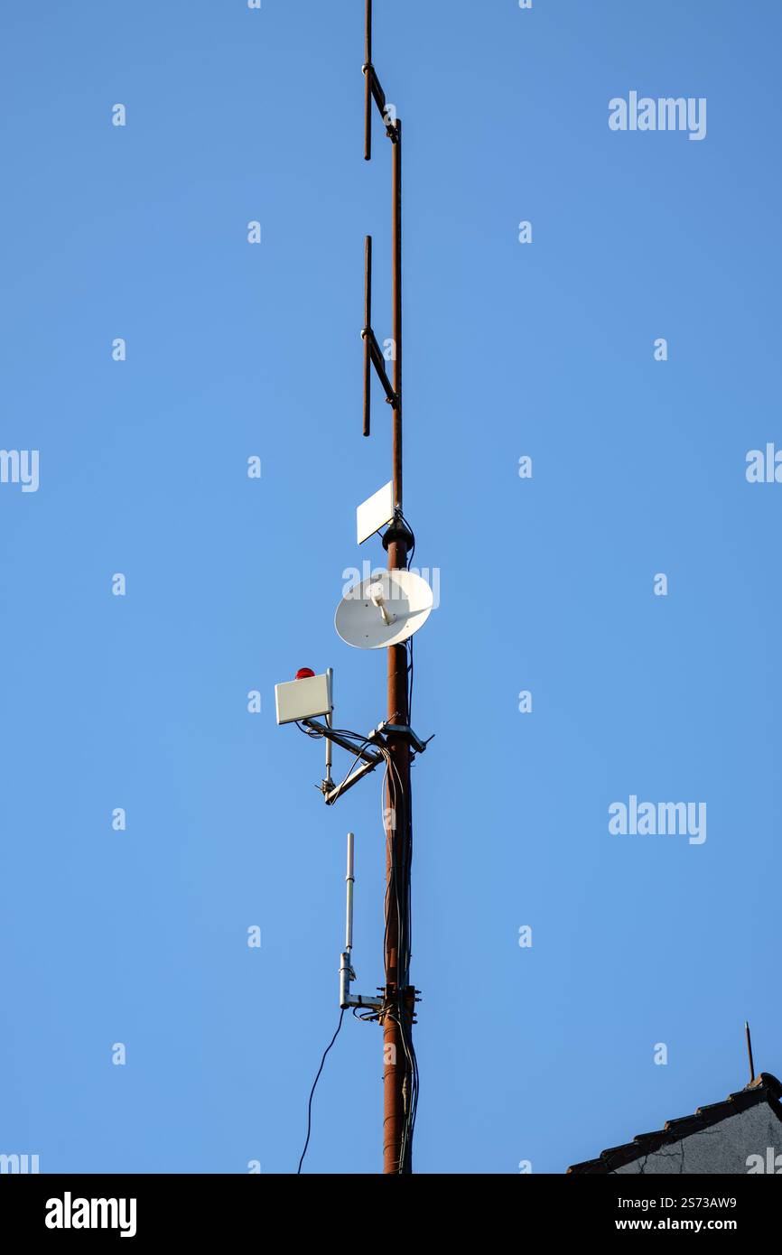 A tall pole with a white and red antenna on top. The pole is surrounded ...