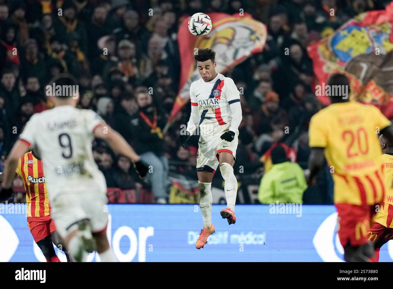 PSG's Desire Doue, center, jumps for the ball during the French League ...