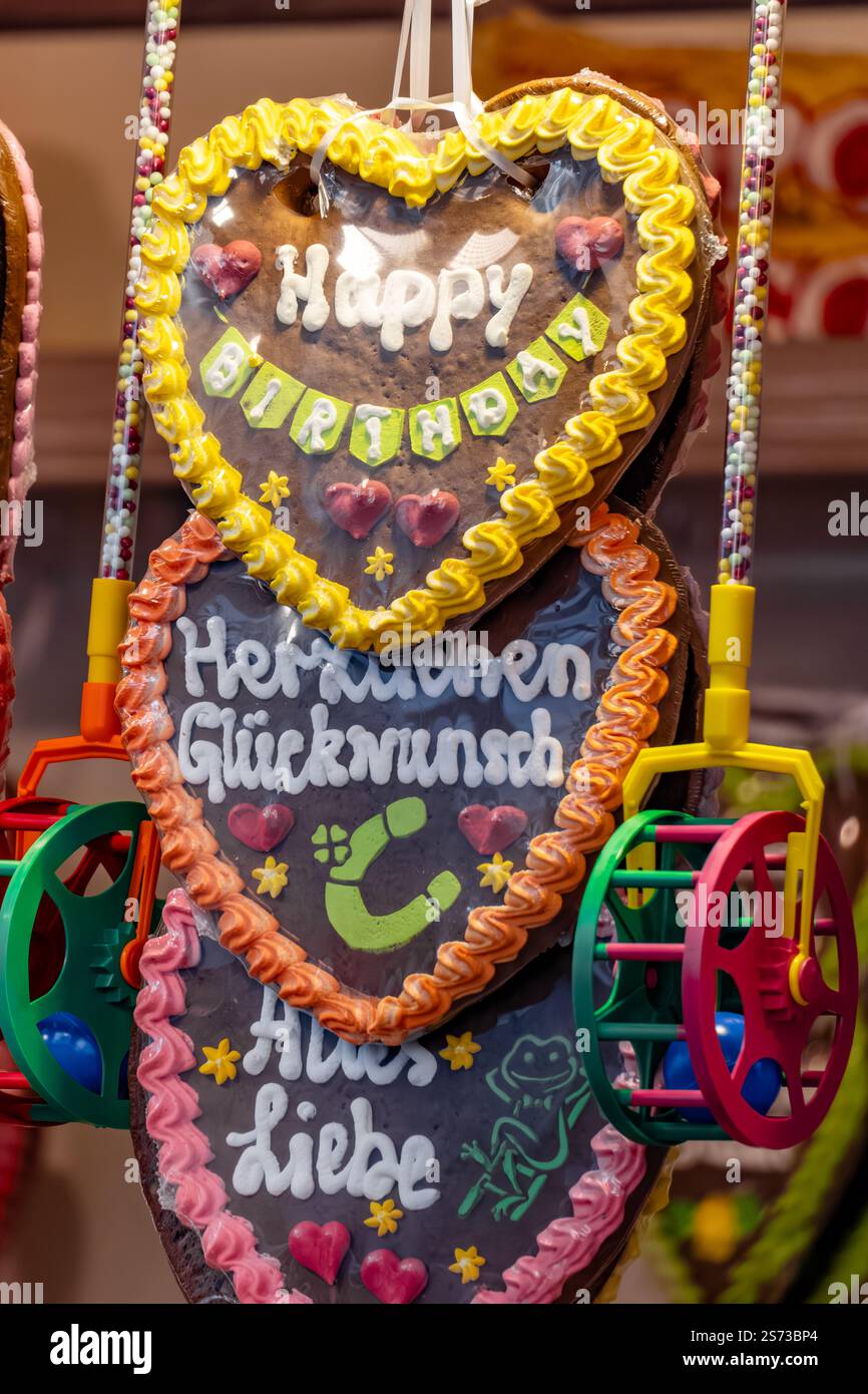 Three heart shaped cookies with the words Happy Birthday and Herzlichen ...