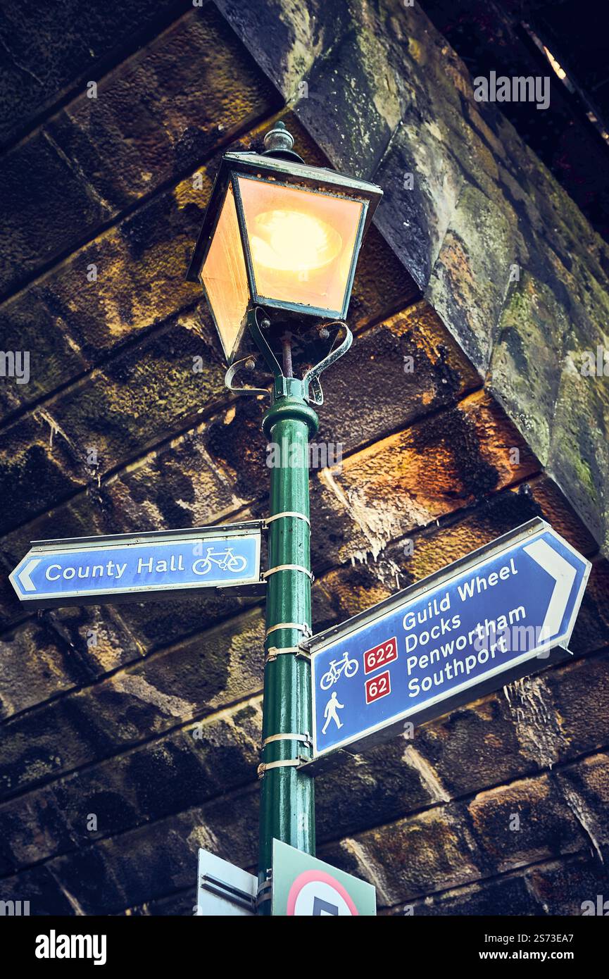 Lamp post and sign post at entrance to railway arch beneathr the west ...