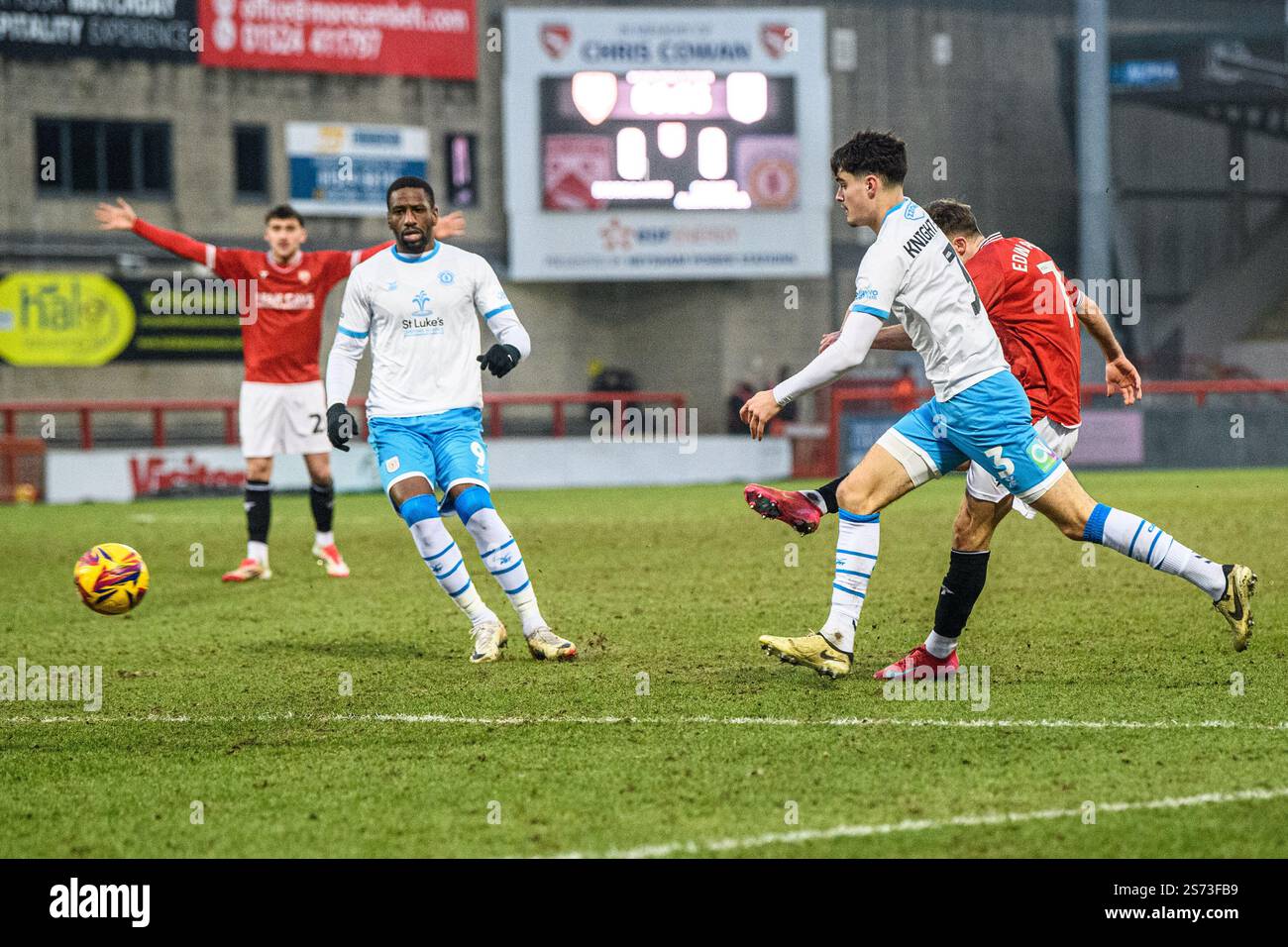 Morecambe FC's Gwion Edwards under pressure from Jamie Knight-Lebel of ...