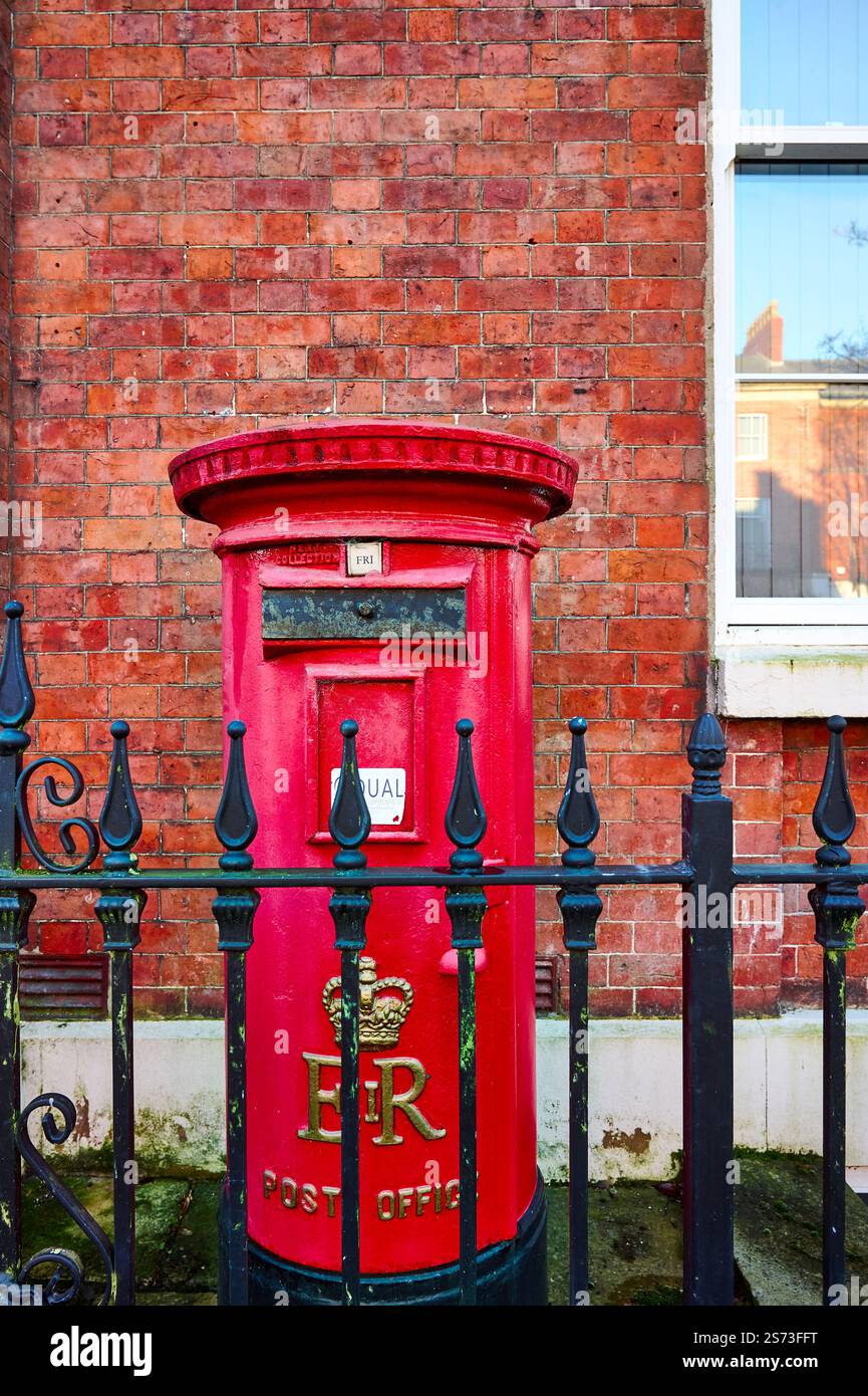 Red post box behind fence in the front garden of a house in Preston,UK ...