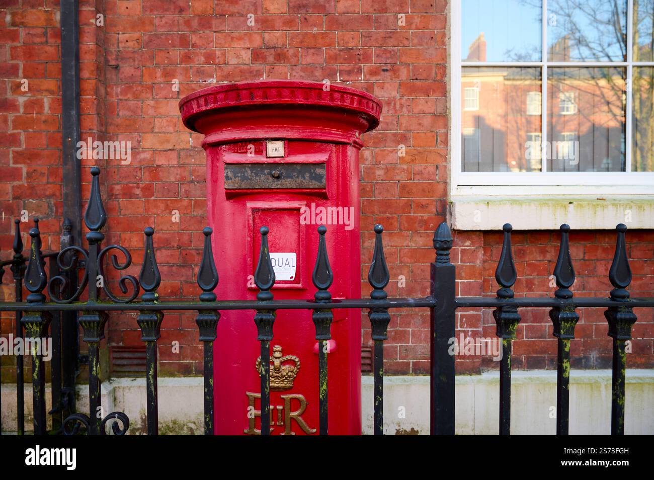 Red post box behind fence in the front garden of a house in Preston,UK ...