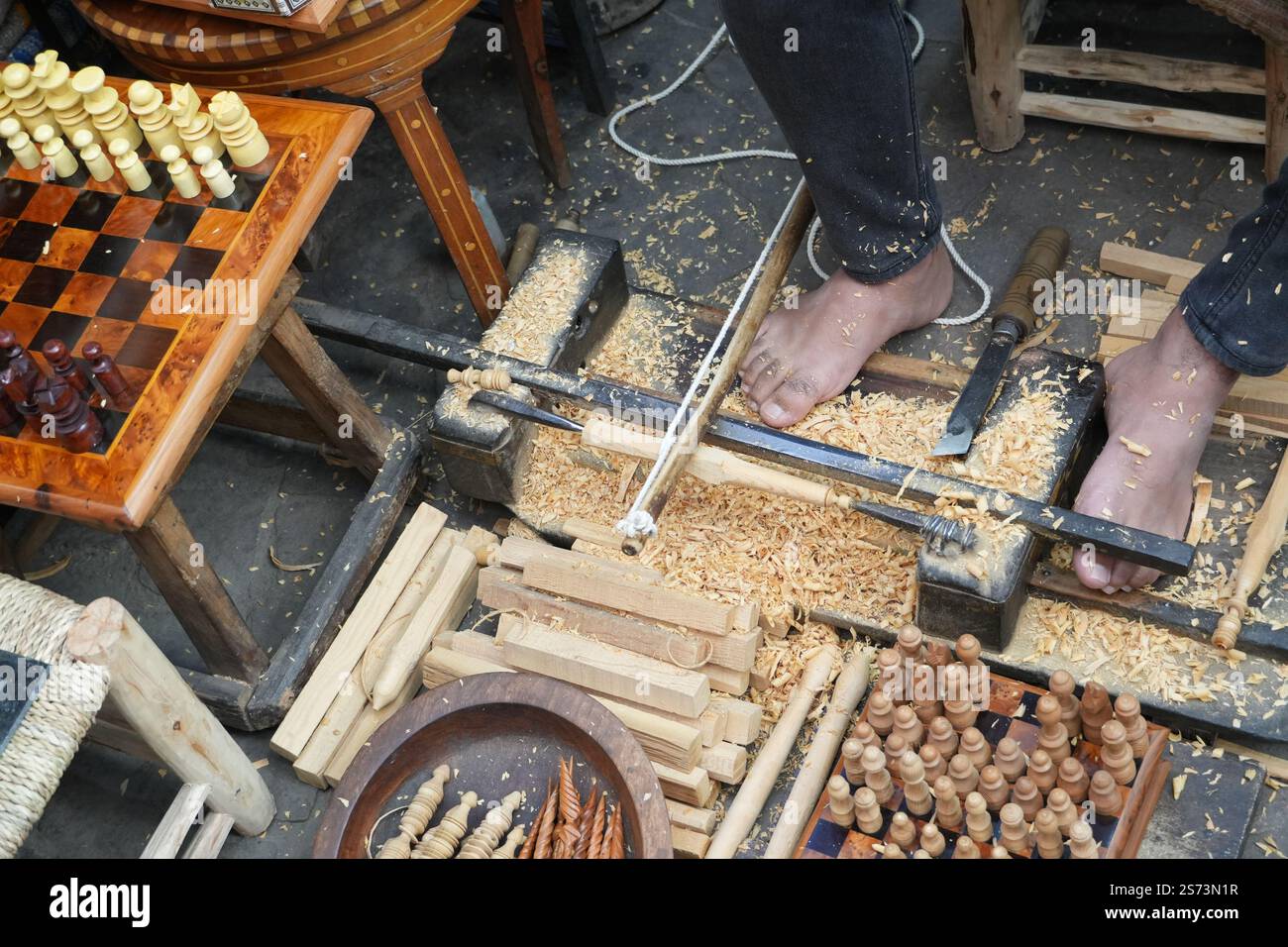 Carpenter working with wood using his feet, Marrakesh, Morocco, North ...