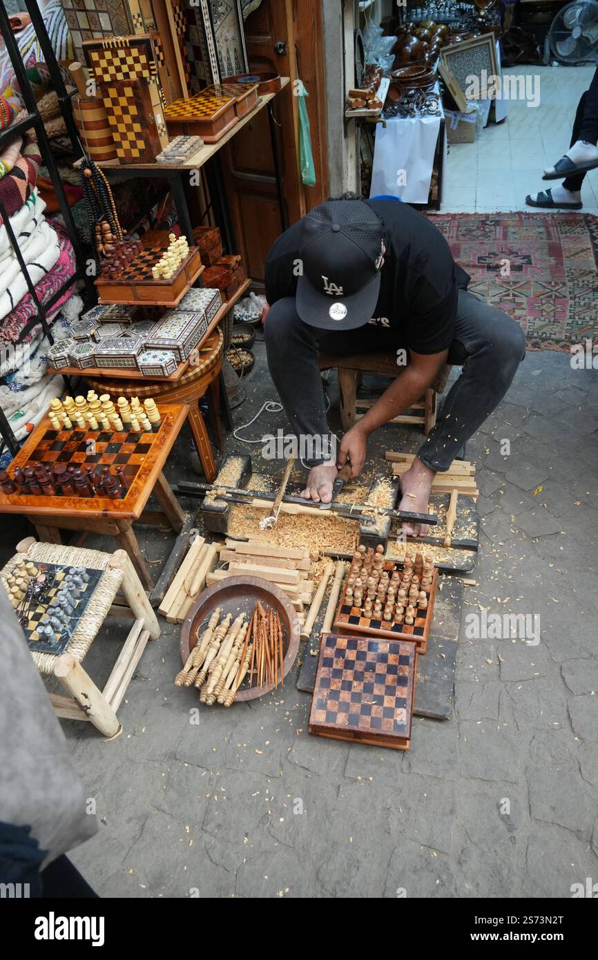 Carpenter working with wood using his feet, Marrakesh, Morocco, North ...
