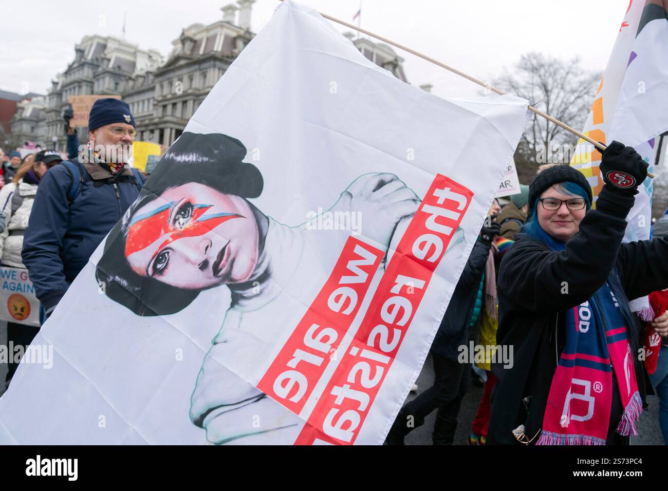 A demonstrator holds a banner during the People's March, Saturday, Jan ...