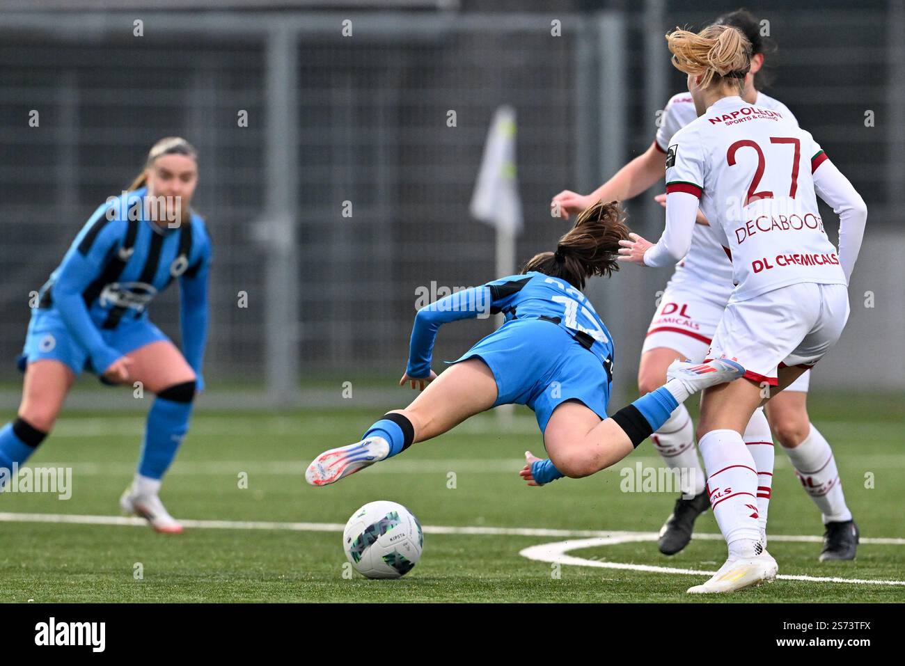 Angel Kerkhove (13) of Club YLA pictured tackled by Marith Decabooter (27) of Zulte-Waregem ...