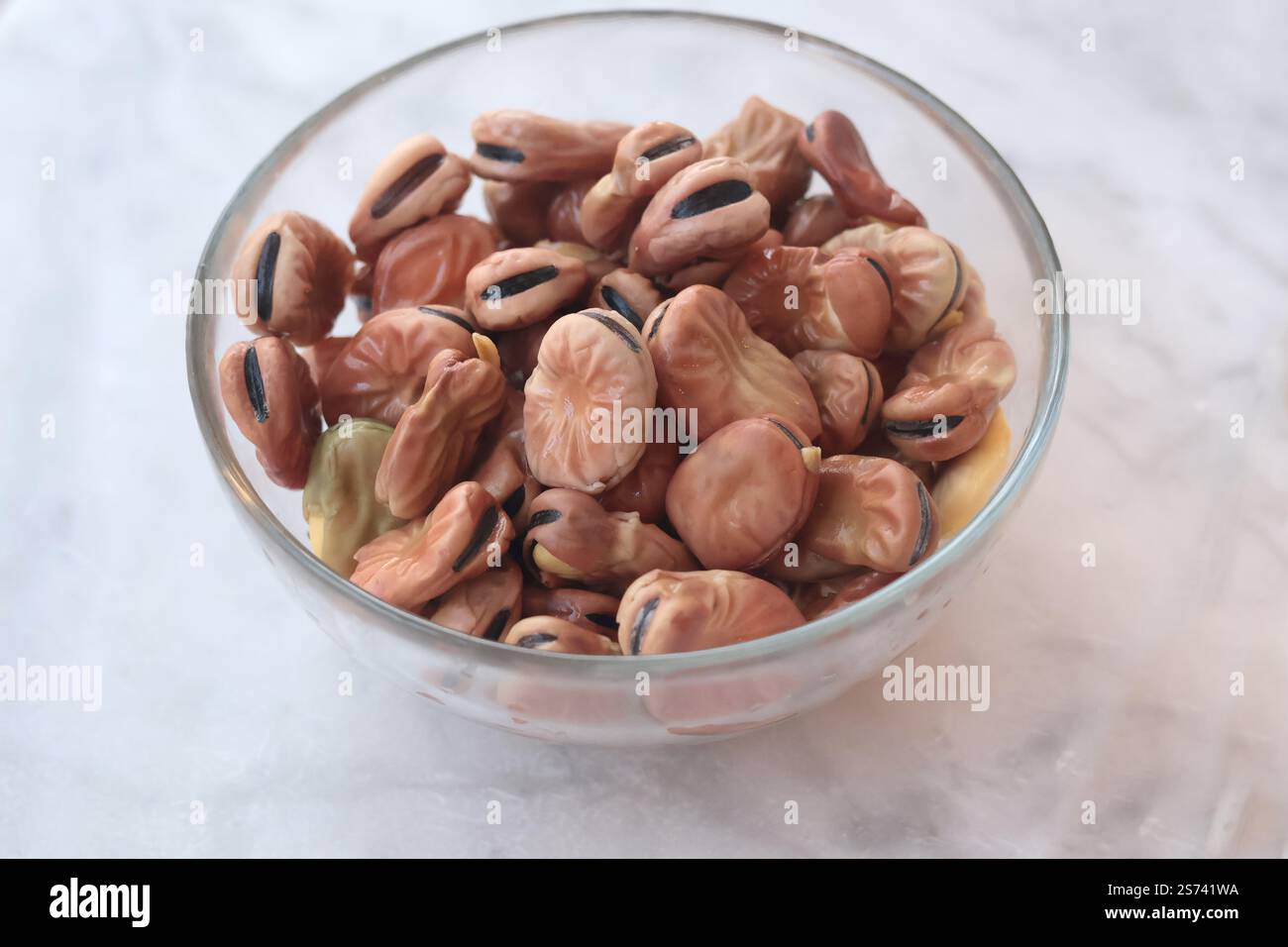 Soaked beans in water in glass bowl on marble table. Food and healthy ...