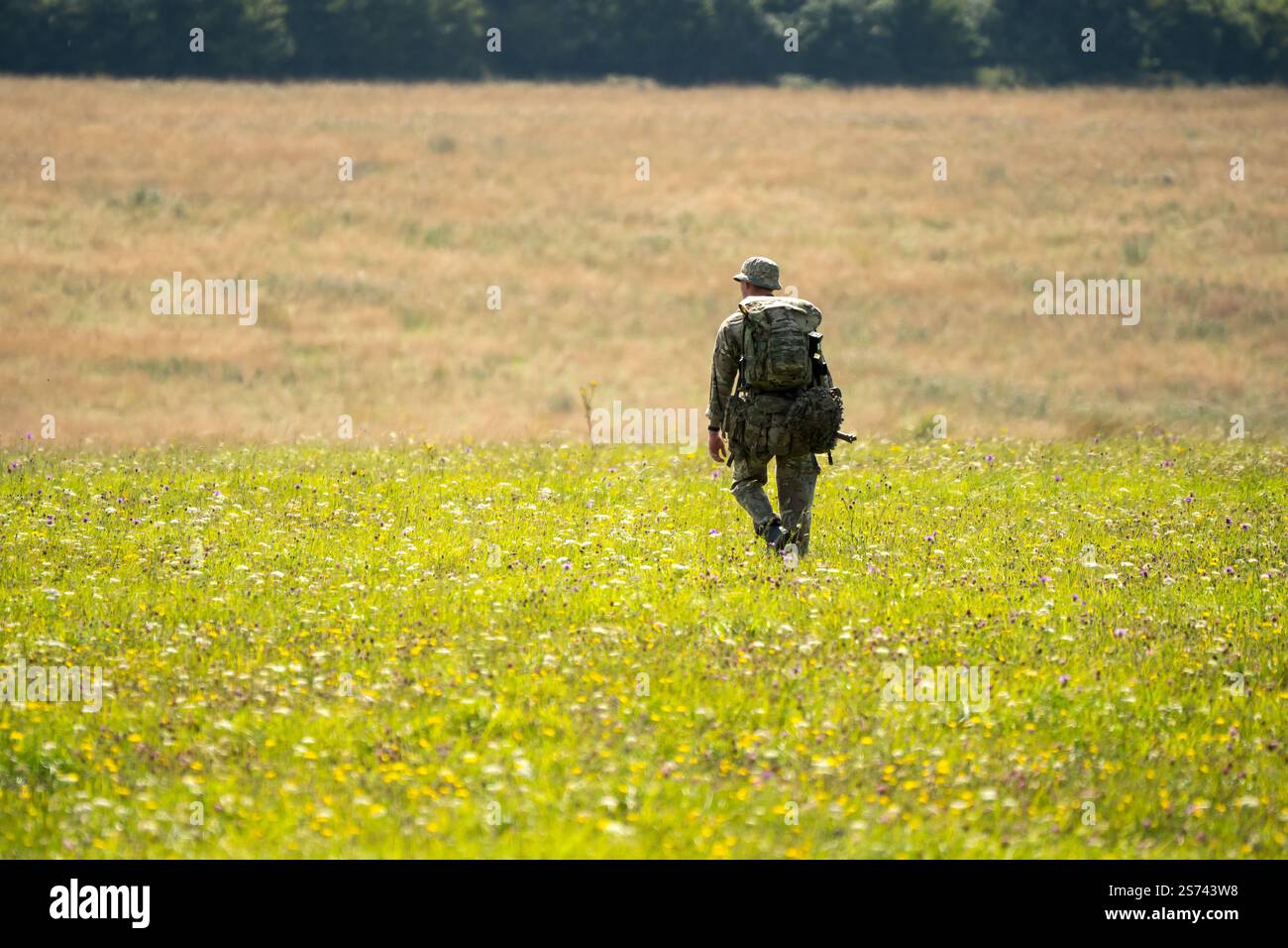 British army soldier with gun on a 40kg loaded march tab military ...