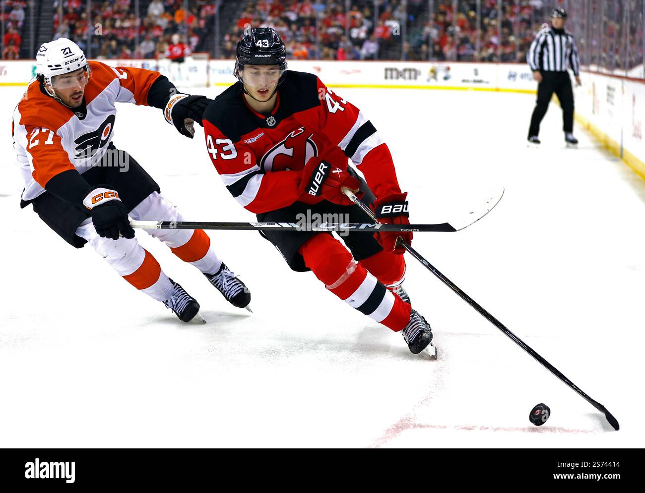New Jersey Devils defenseman Luke Hughes (43) plays the puck ahead ...