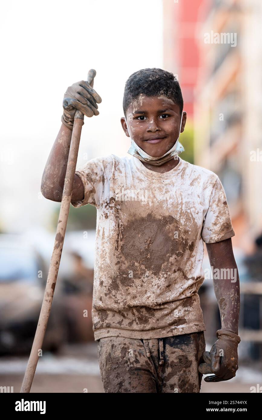 Black boy covered in mud looking at camera proudly with positive ...