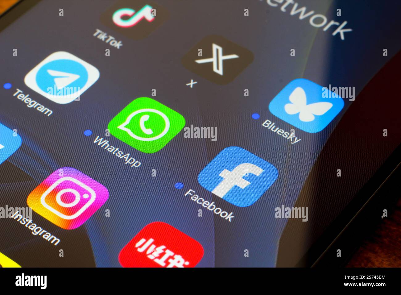 In this photo illustration, the social media apps TikTok, X (Twitter), BlueSky, WhatsApp ...