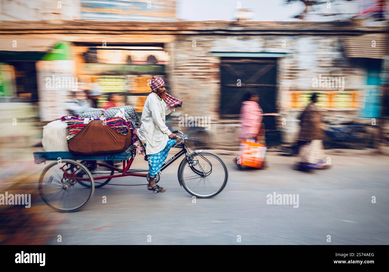 A local clothing vendor in Varanasi carrying clothes on Tricycle, India ...