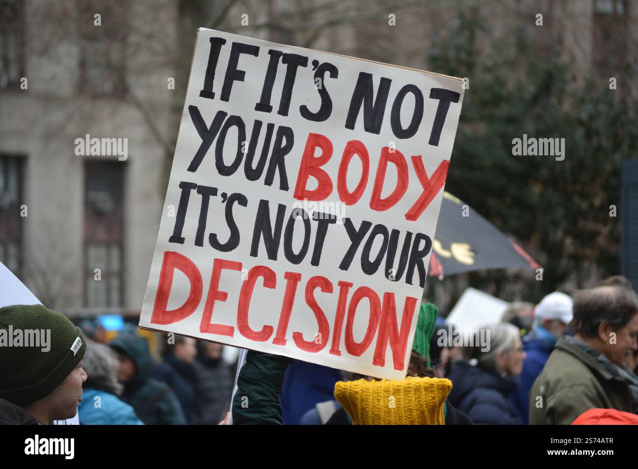 Person holding a sign at the 2025 People's March against the incoming ...