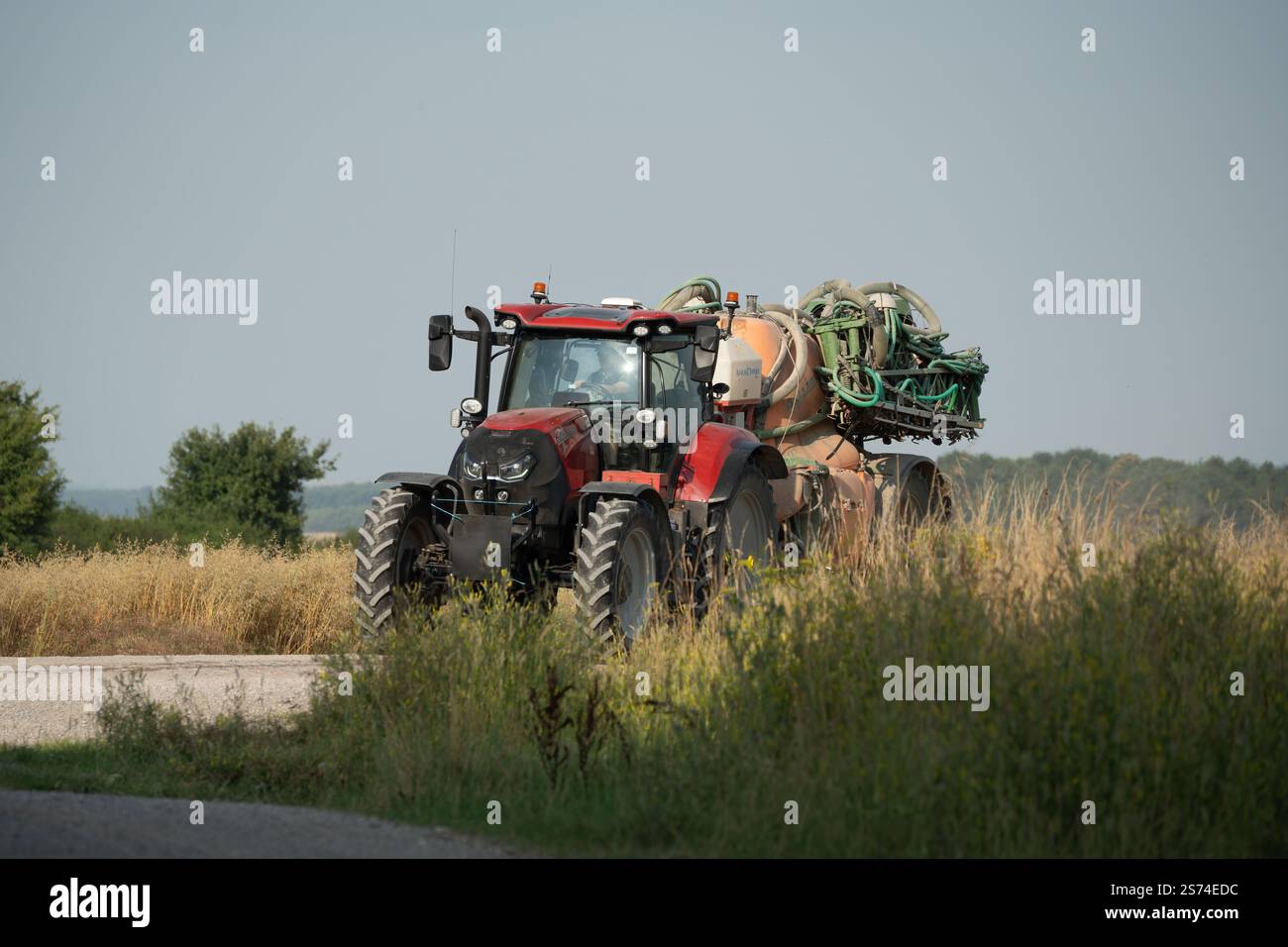 Red Case Puma 340 large red tractor with towed crop sprayer attached ...