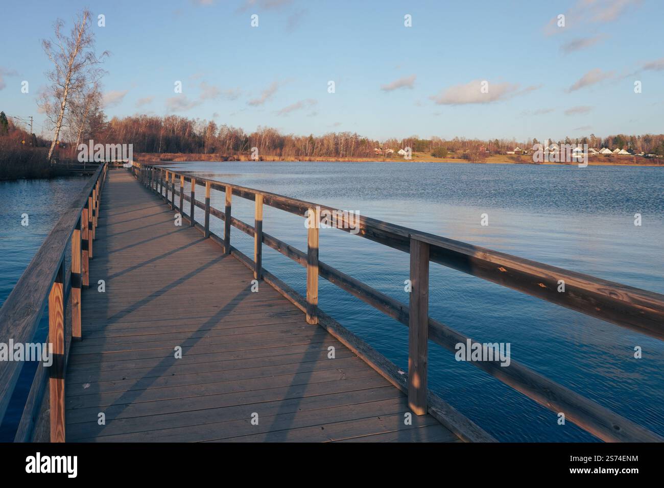 A wooden walk bridge over water Stock Photo - Alamy