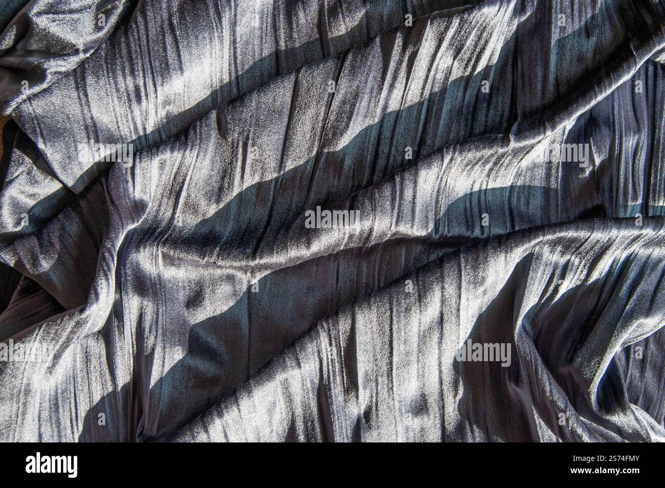 Reflective silver material with soft creases and folds Stock Photo - Alamy