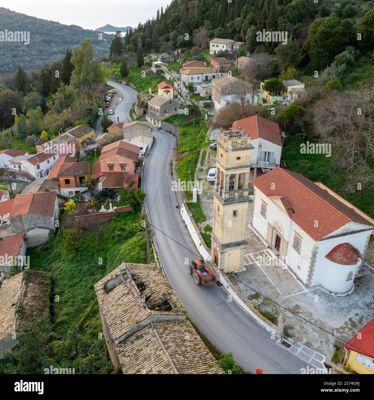 Aerial view of a quaint village nestled in a hillside, featuring a ...