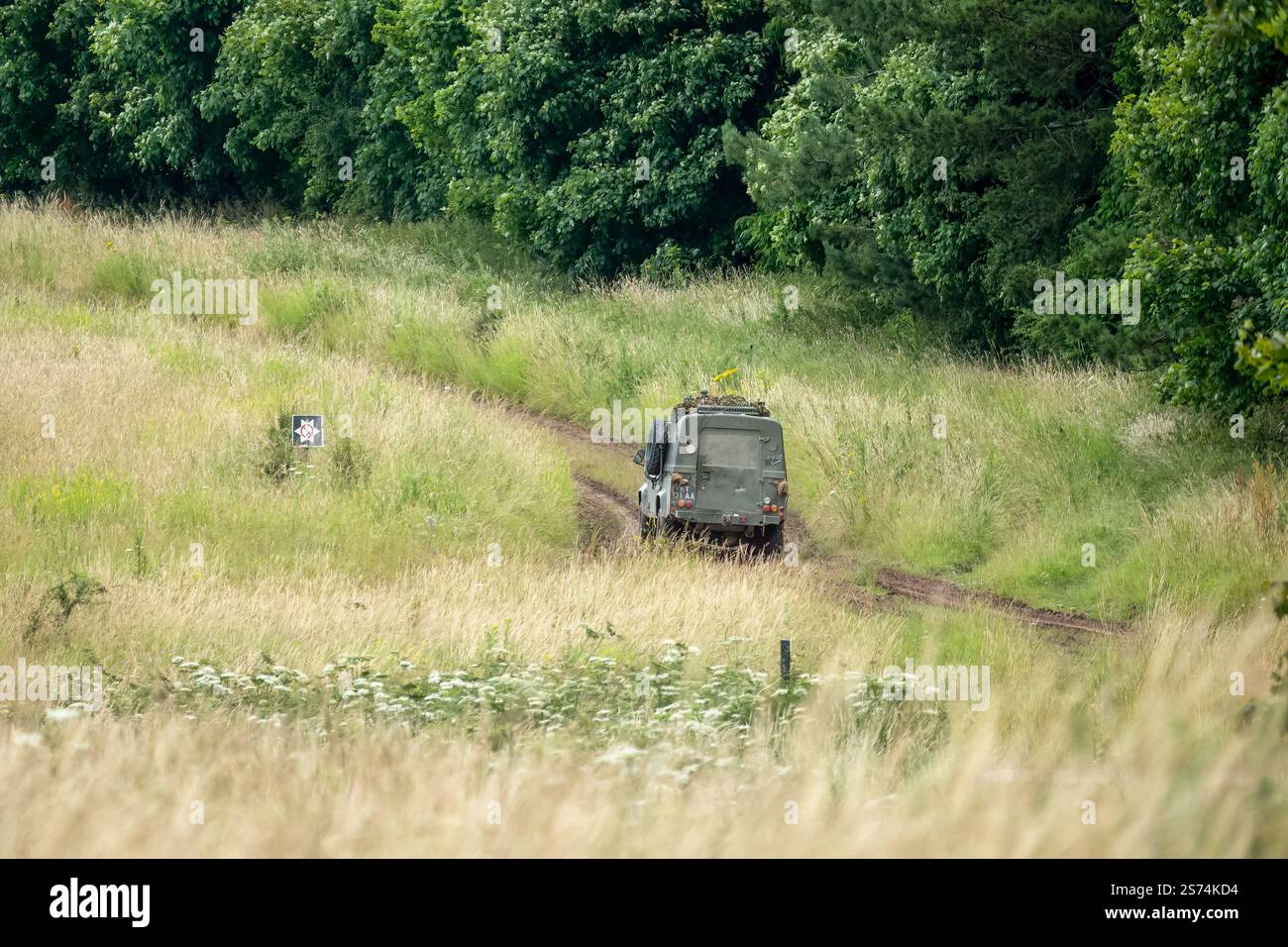 a British army Land Rover Wolf utility vehicle moving through open ...