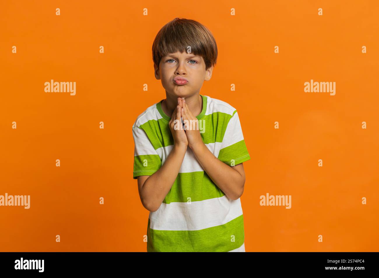 Please, God help. Preteen child boy kid praying making wish, asking ...