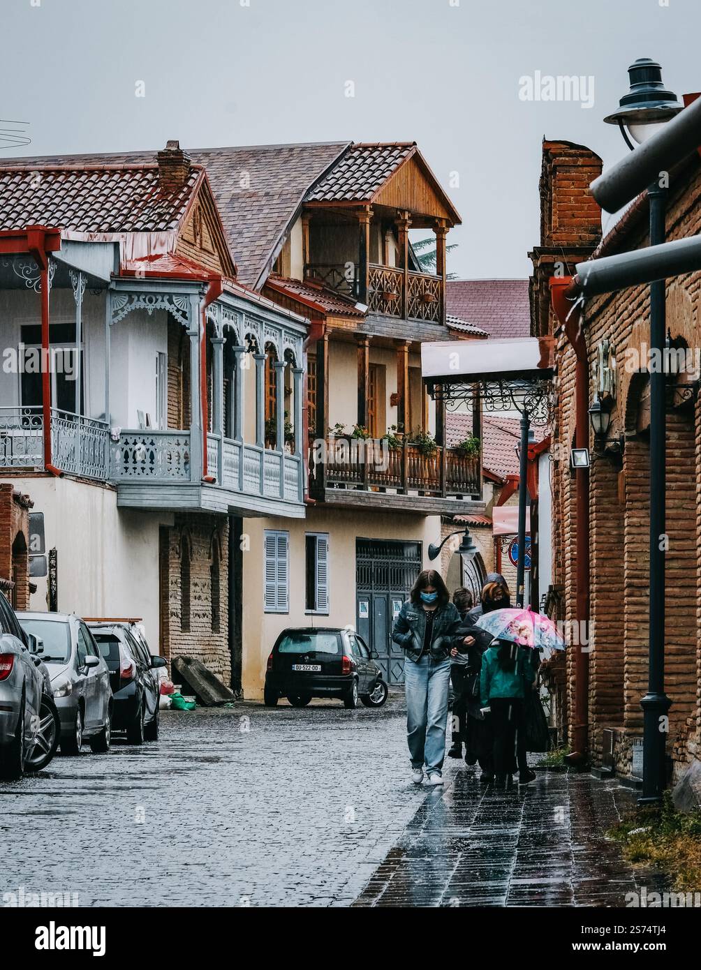 Teenagers on a rainy day in Cholokashvili Street with its traditional ...