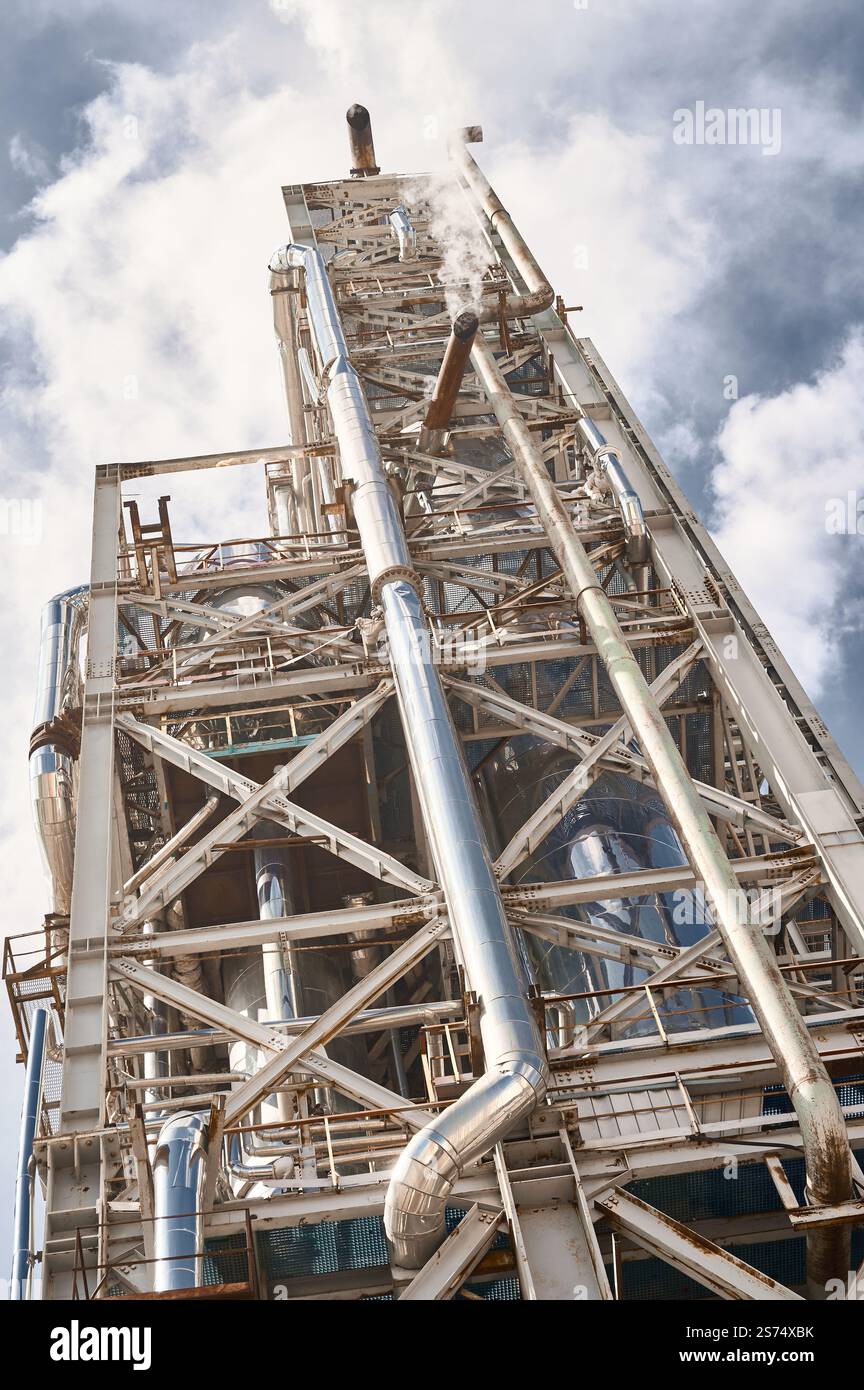 View of a towering chemical plant infrastructure under a cloudy sky ...