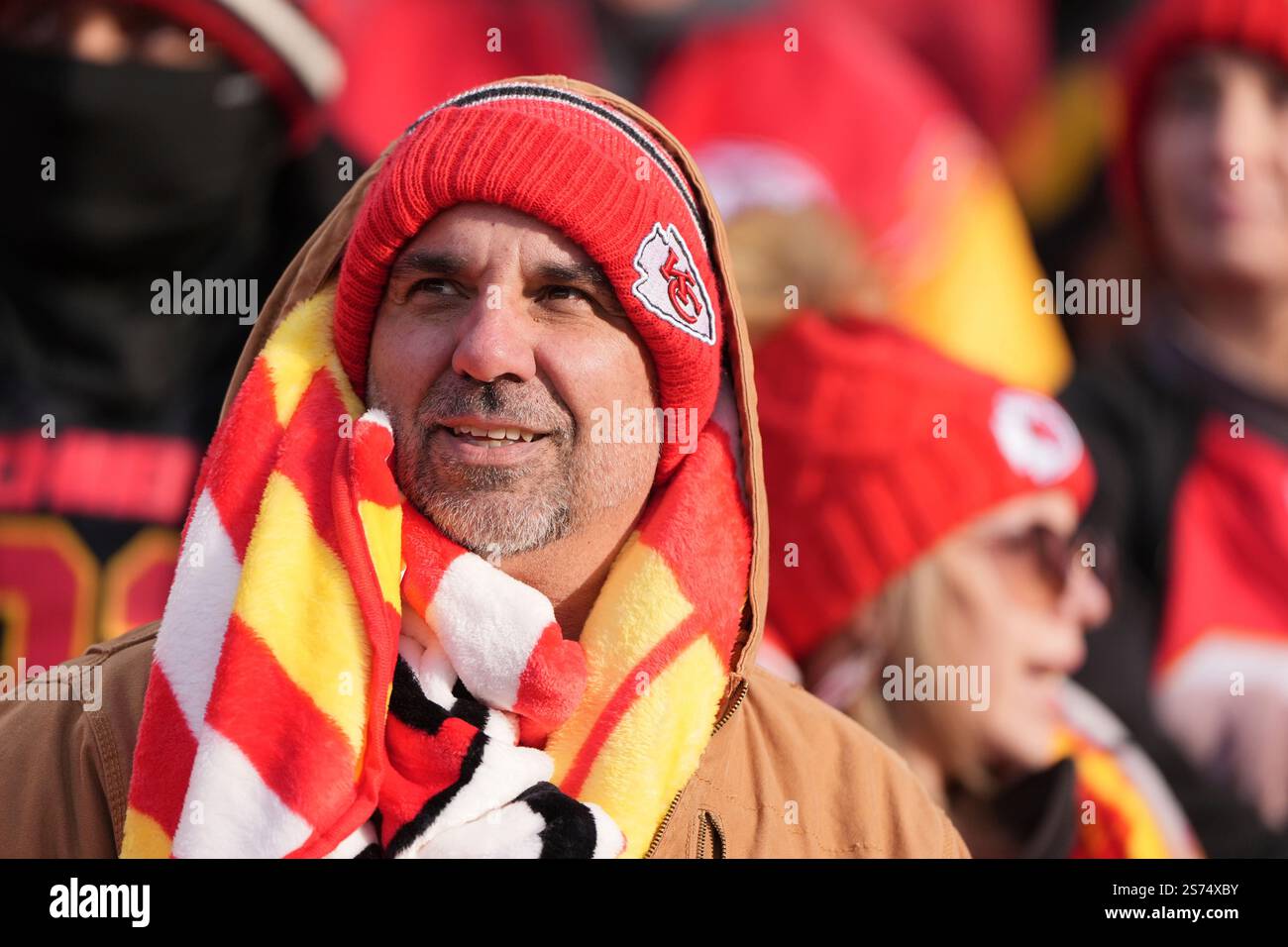 A fan is bundled up for the cold before an NFL football AFC divisional ...