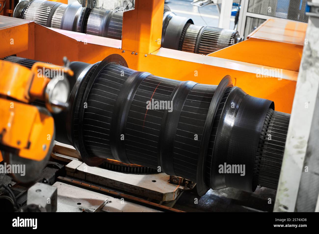 Rubber workpiece on shaft forming tire in factory workshop Stock Photo ...