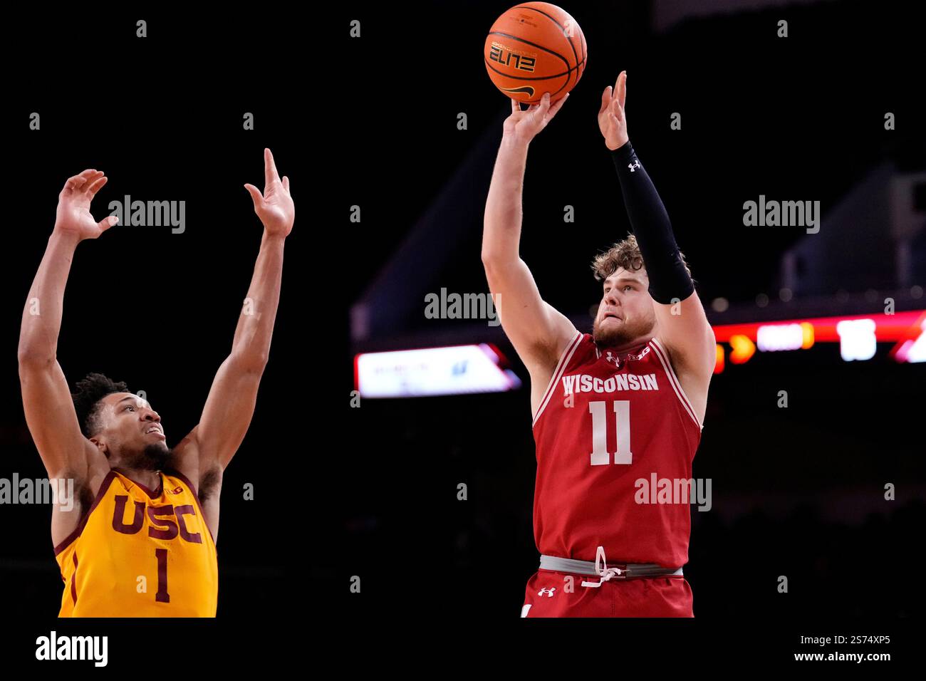 Wisconsin guard Max Klesmit, right, shoots as Southern California guard ...