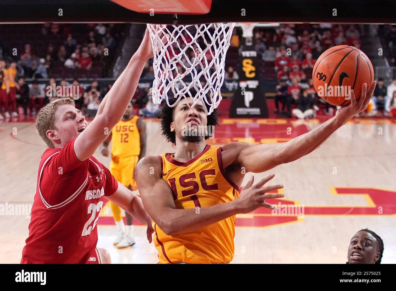 Southern California guard Desmond Claude, right, shoots as Wisconsin ...