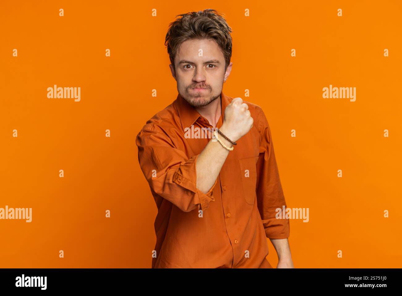 Aggressive angry Caucasian young man trying to fight at camera, shaking ...