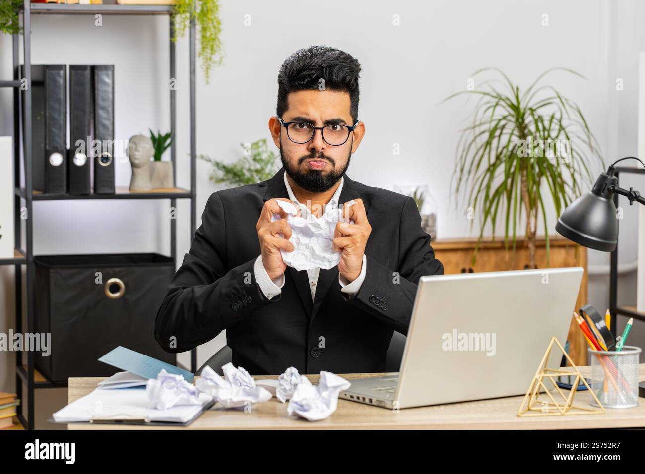 Angry furious Hindu man working at office throwing crumpled paper ...