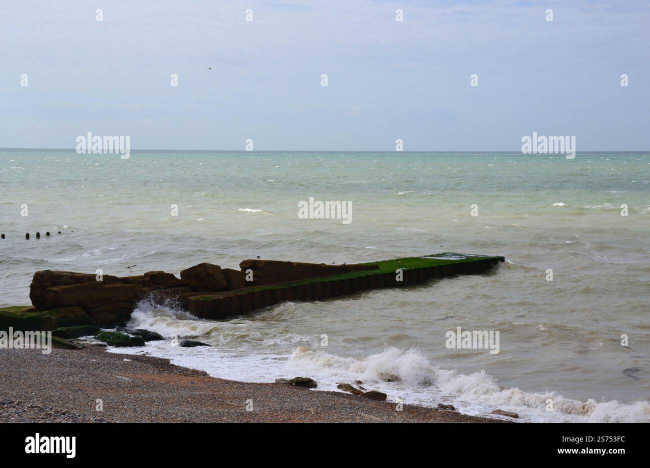 View of sea and wave breakers from Seaford beach, East Sussex, England ...