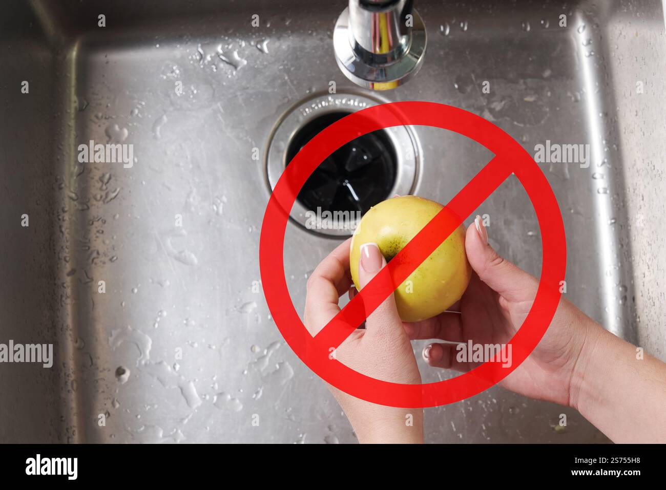 Hand washing apple in sink with red prohibition sign symbolizing ...