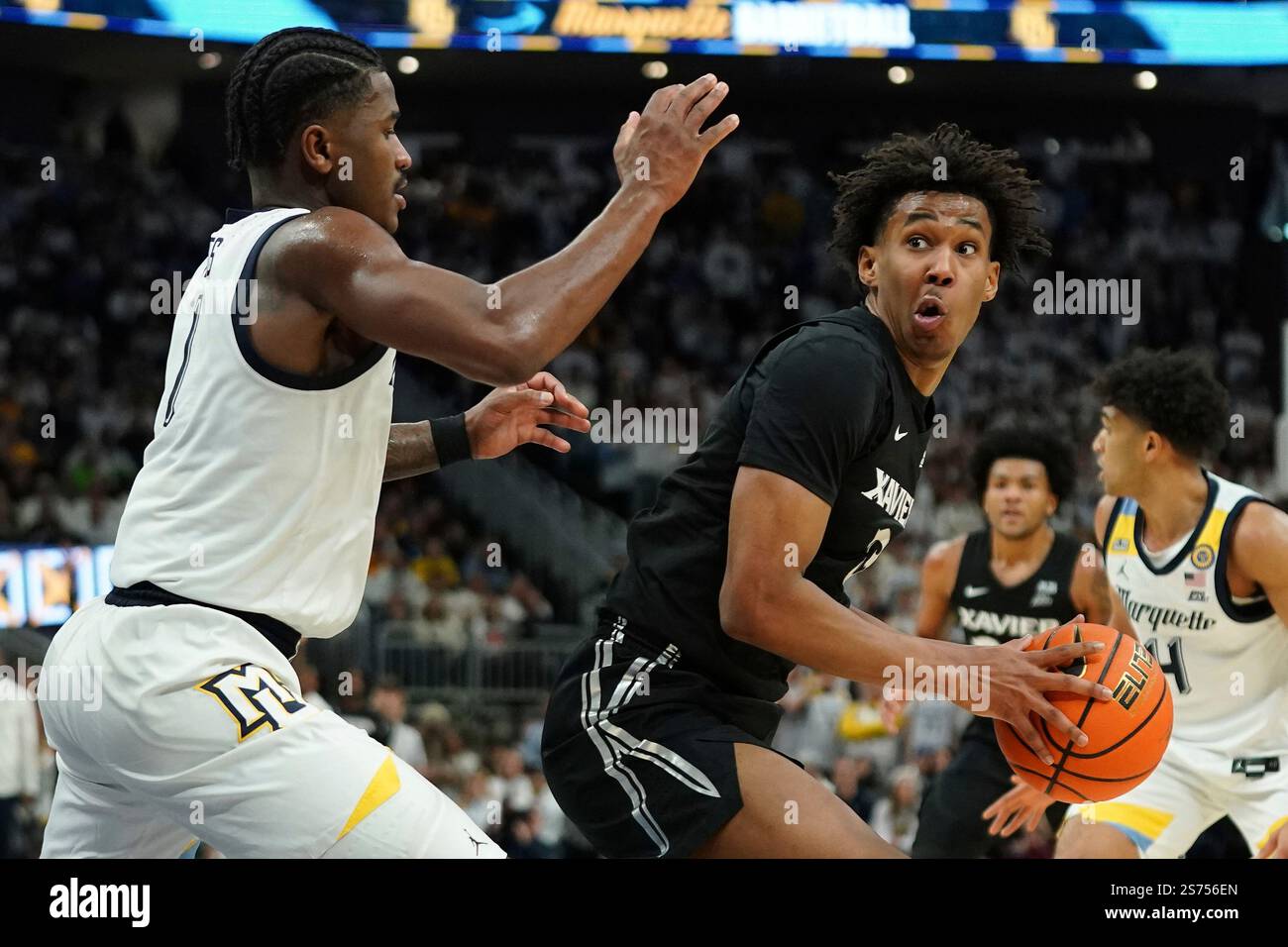 Xavier's Dailyn Swain, right, looks to shoot against Marquette's Kam ...