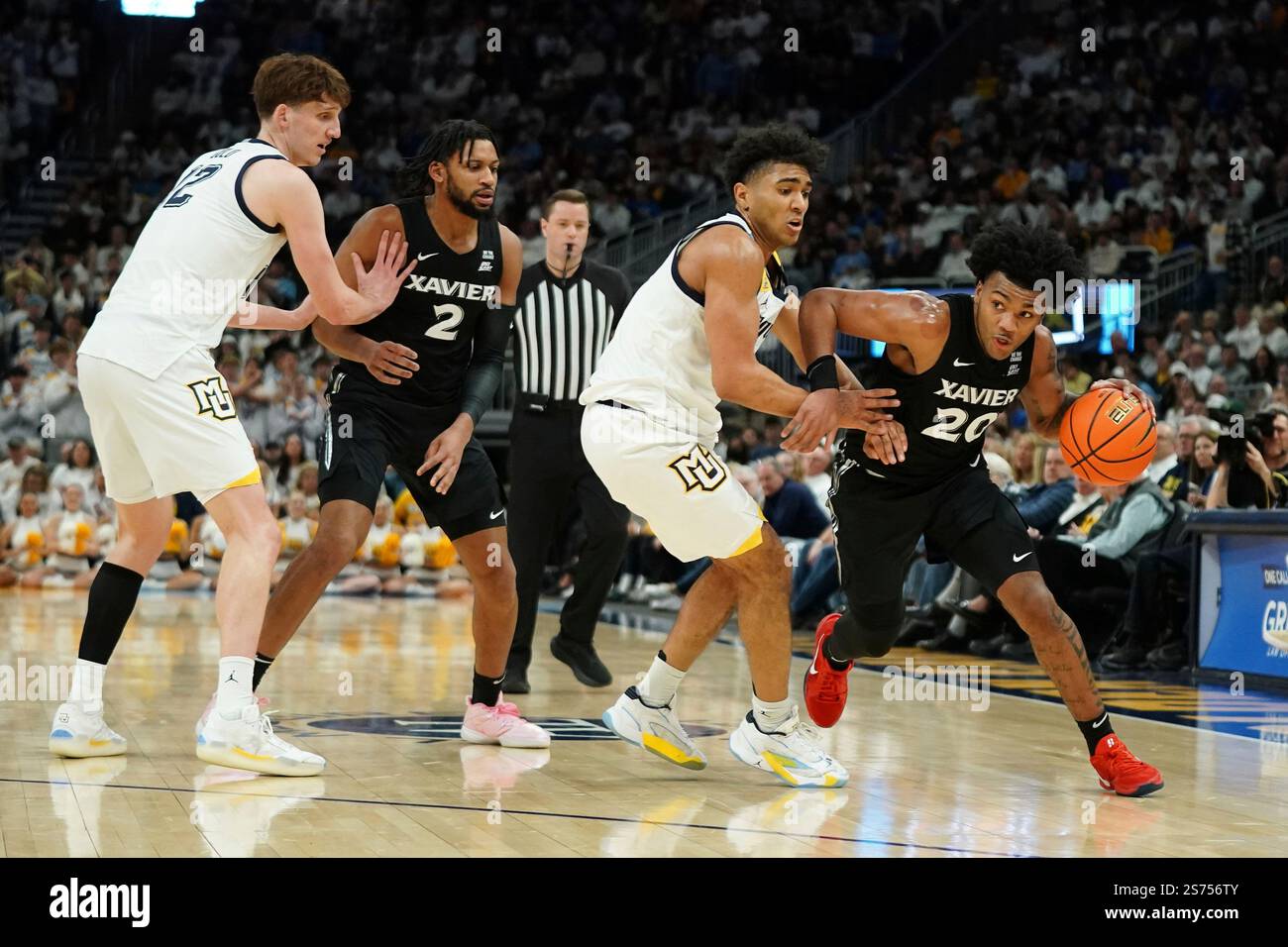 Xavier's Dayvion McKnight (20) drives to the basket against Marquette's ...