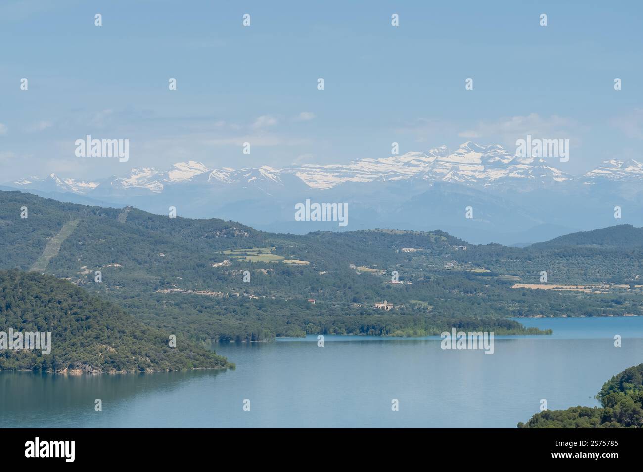 water, hills and distant Pyrenees mountains at Embalse de El Grado ...