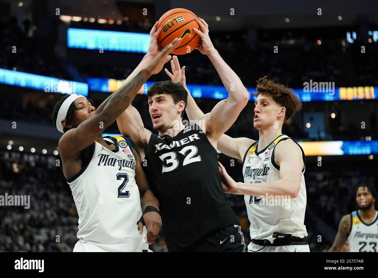 Xavier's Zach Freemantle (32) drives between Marquette's Chase Ross (2 ...